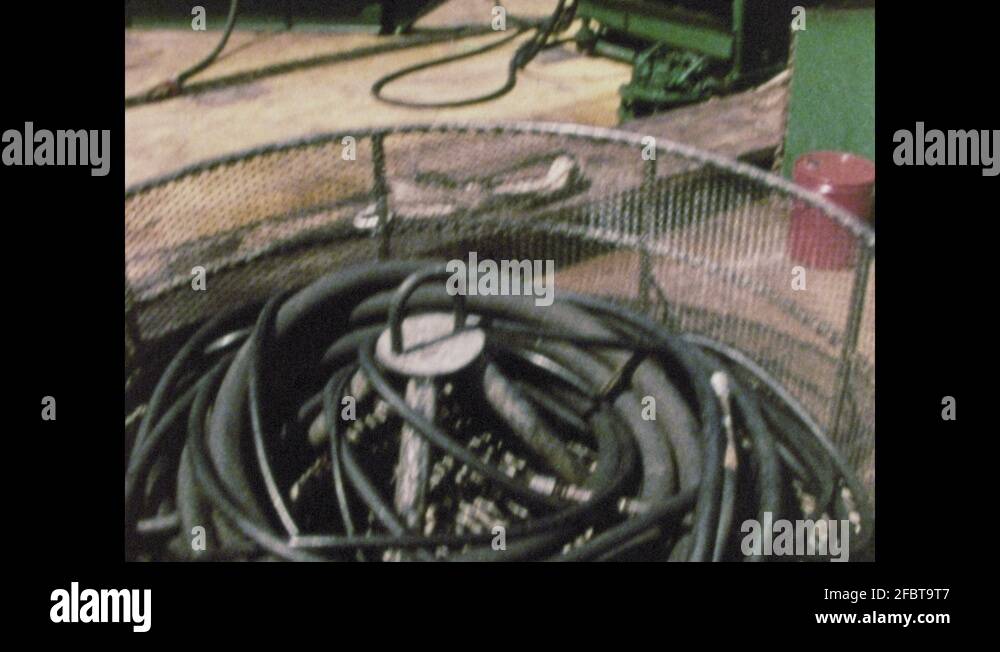 1960s: UNITED STATES: drilling equipment and crews on rigs. Helicopter ...