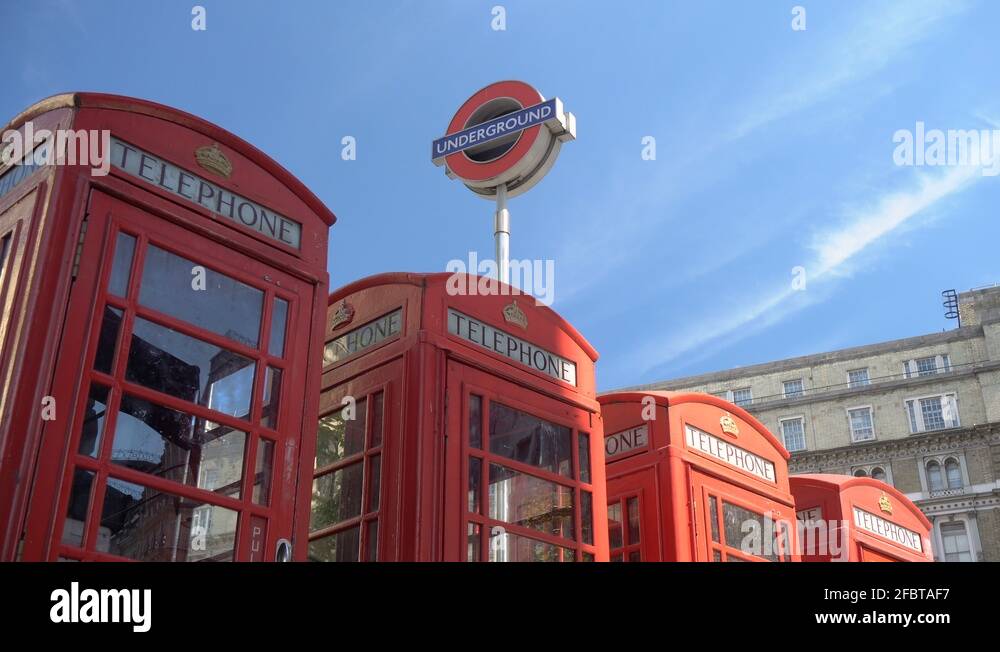 Four Red Telephone Booths and Underground Station Sign in London, UK ...