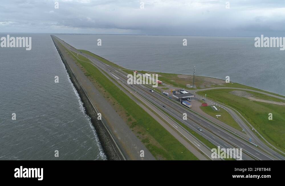 Gentle ARIAL DOLLY BACK of the De Afsluitdijk dam and highway, Netherlands Stock Video Footage ...