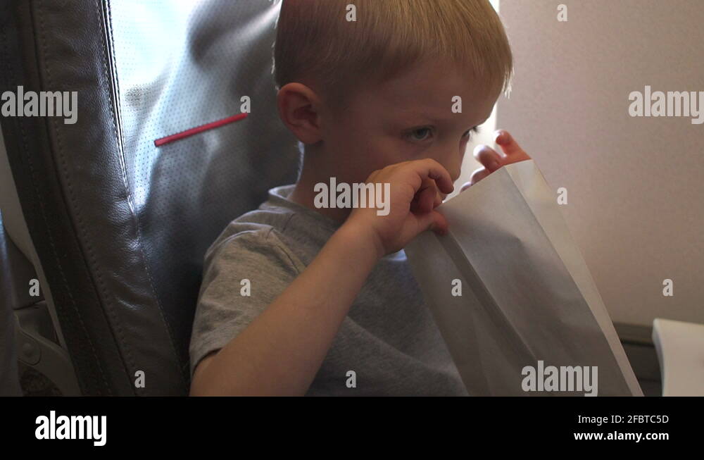 Close-up of a little boy vomits in an airplane during a flight Stock ...