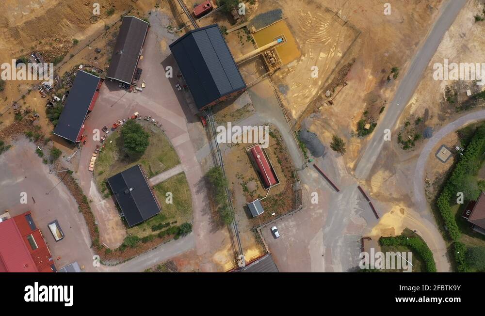 Reverse overhead drone footage showing buildings from Falu copper mine ...