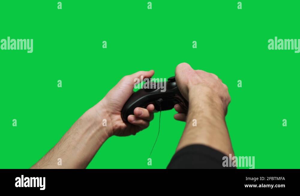 Side view of gamer playing game with controller, green screen Stock ...