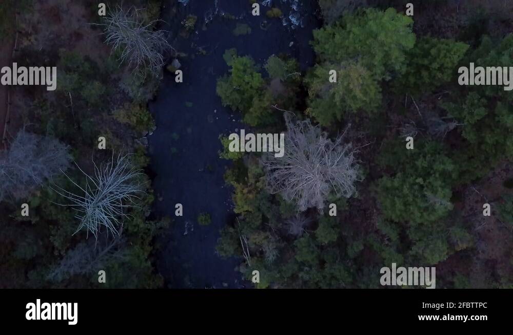 Drone following river from top down view to reveal Burney Falls ...