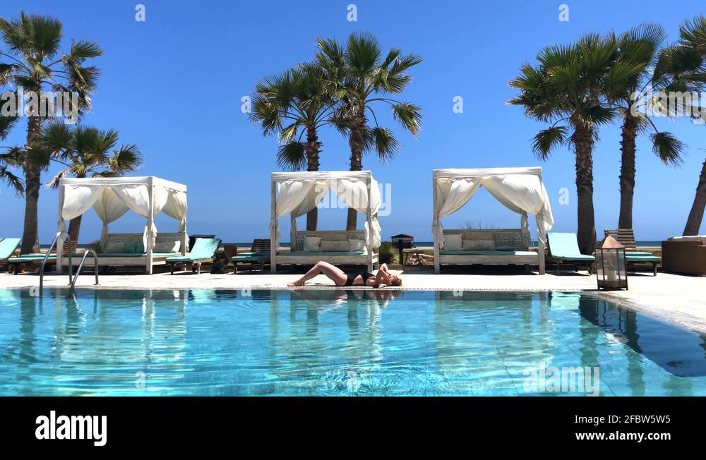 Woman sunbathing by a swimming pool Stock Videos & Footage - HD and 4K ...