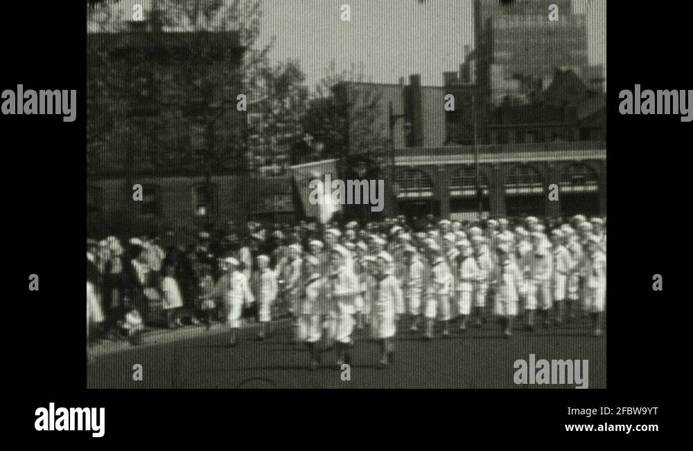 1930s: men in uniform marching in parade, marching band in parade Stock ...