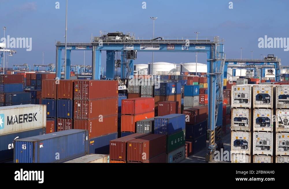 Loader being extended above shipping containers, Seaport with cargo ...
