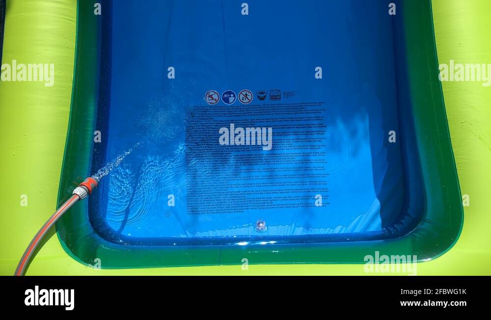 [Static, top down view] Nozzle and hose lying on pool corner, slowly ...