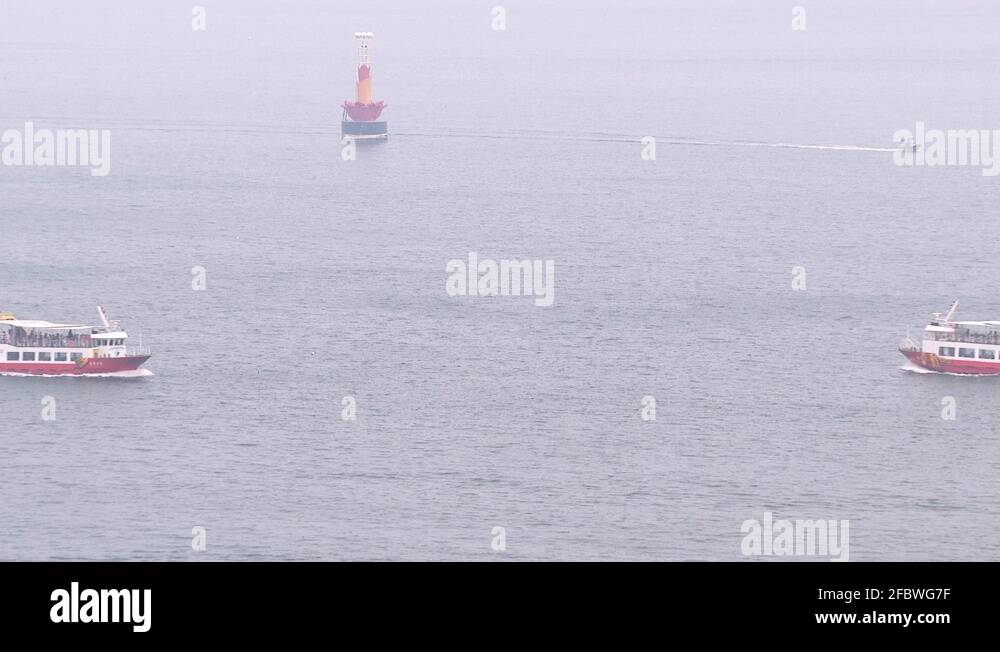Two South Korean ferries pass each other near Haeundae Beach, Busan ...