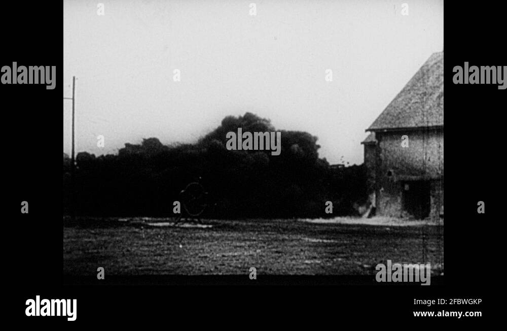 1940s: Soldier hide in tall grass, shoot bazooka. Explosion next to ...