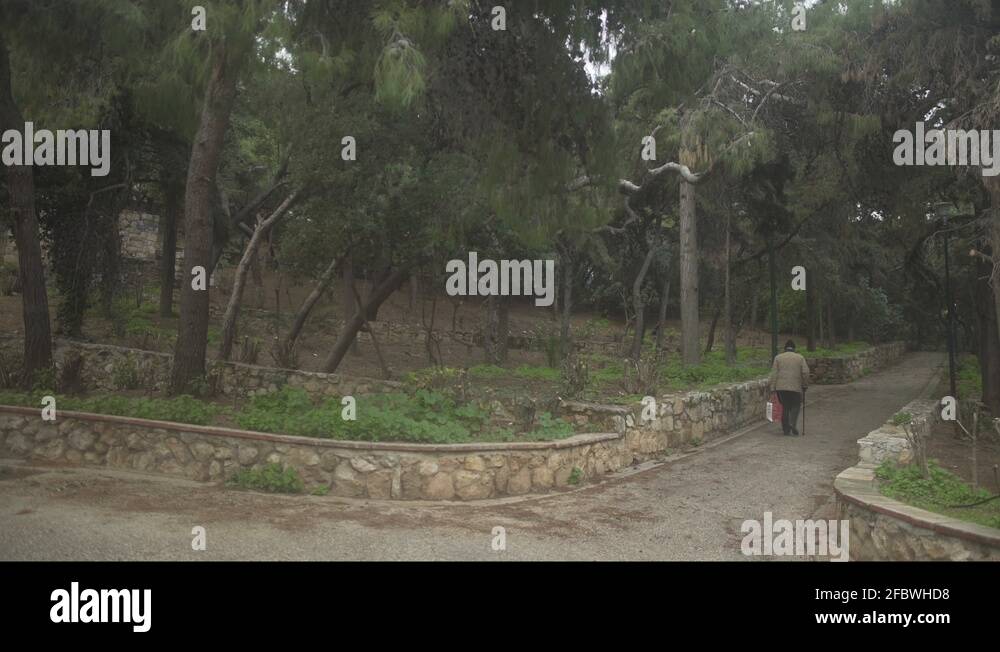 Old man walking alone with a bag in a park in Athens, Greece Stock ...