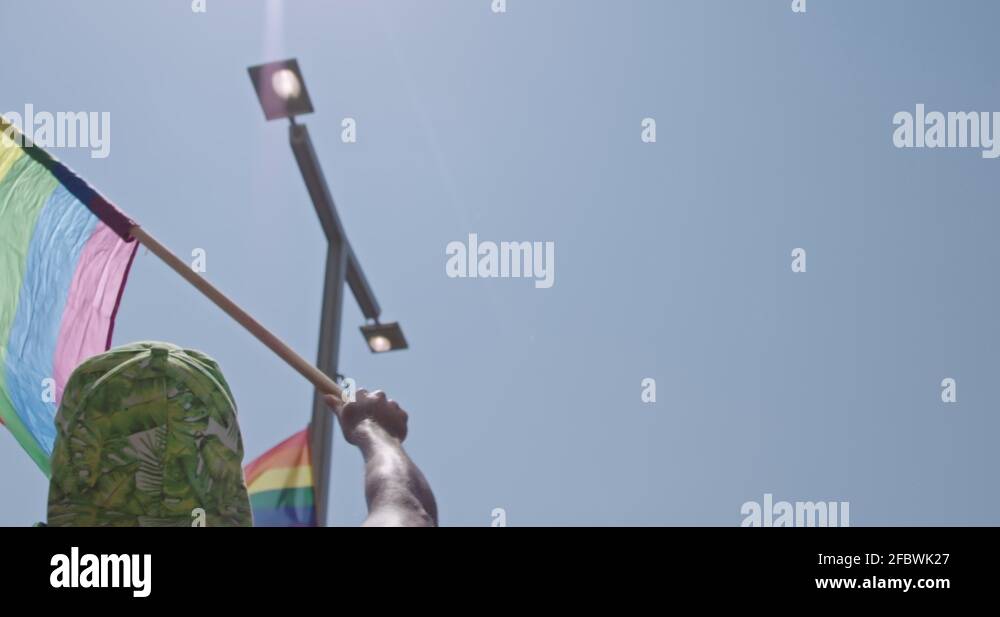 Pride LGBT rainbow flag waving in slow motion during a pride parade ...