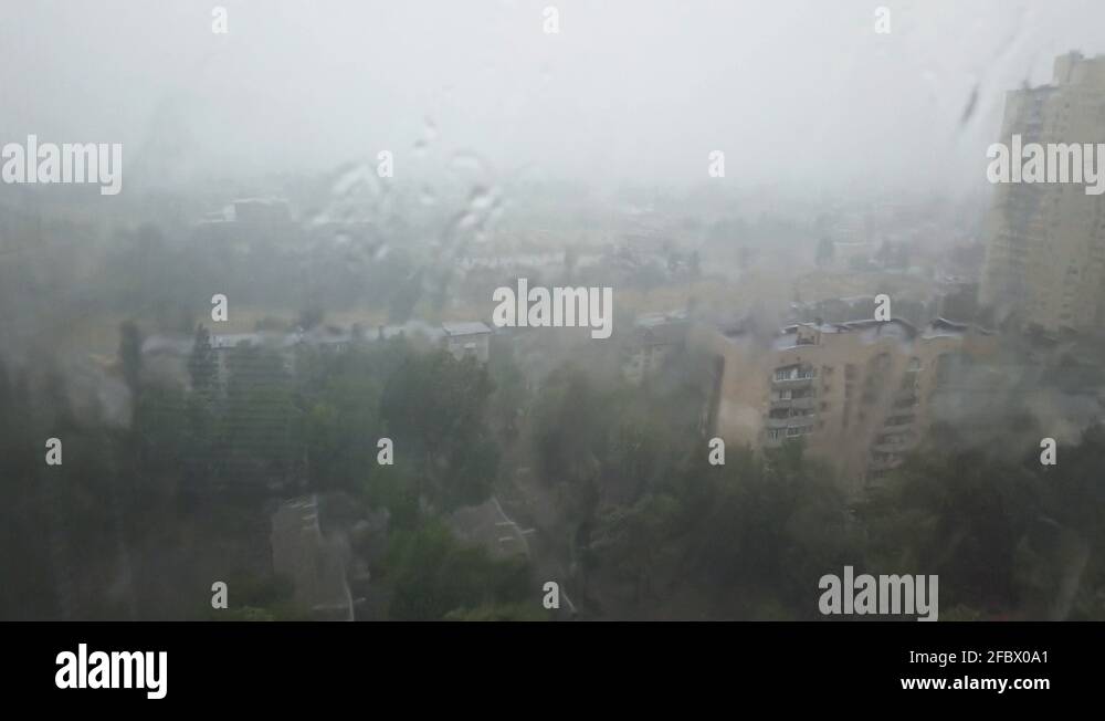 Heavy storm rain through window Stock Video Footage - Alamy