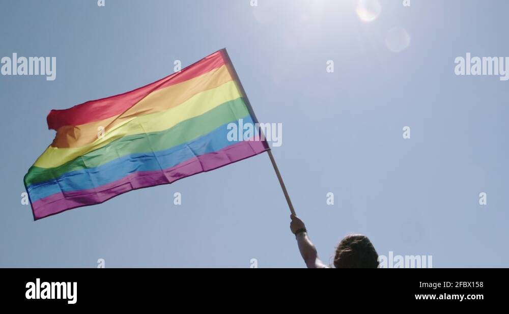 Pride LGBT rainbow flag waving in slow motion during a pride parade ...