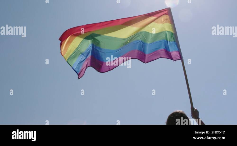 Pride LGBT rainbow flag waving in slow motion during a pride parade ...