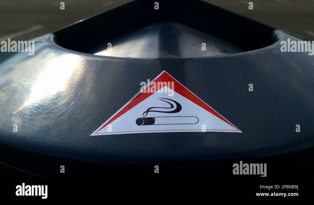 Hazardous smoking sign ash tray on a dustbin, reveal close up shot ...