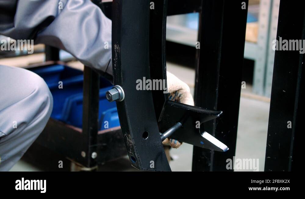 Mechanic working with pneumatic wrench while manual and mechanic ...