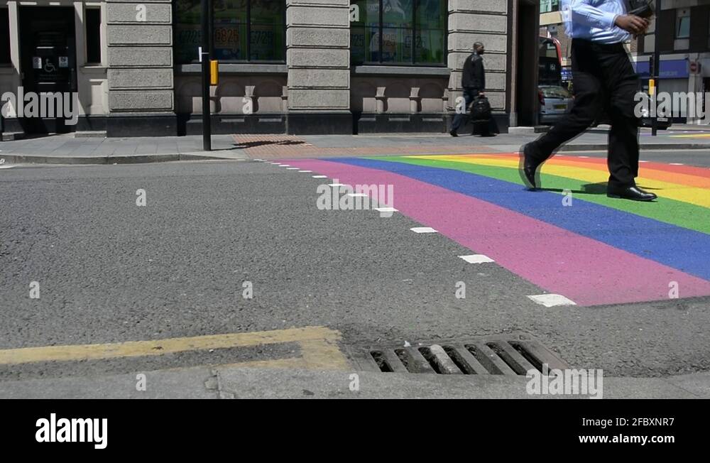 People at Rainbow street pedestrian crossing at intersection in London ...