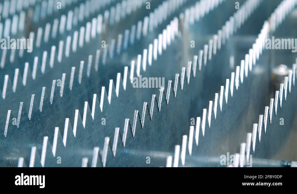Rows of metal plates with sharp edges in machine tool. Manufacturing ...