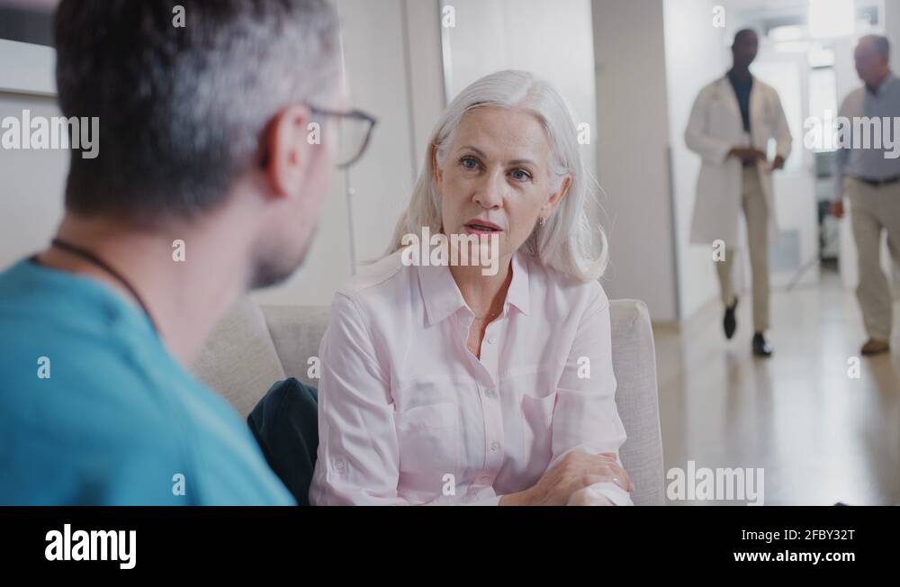 Doctor Welcoming To Senior Female Patient Being Admitted To Hospital ...