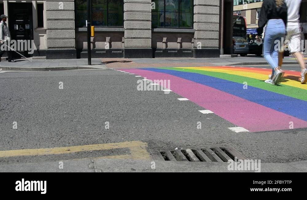 People at Rainbow street pedestrian crossing at intersection in London ...