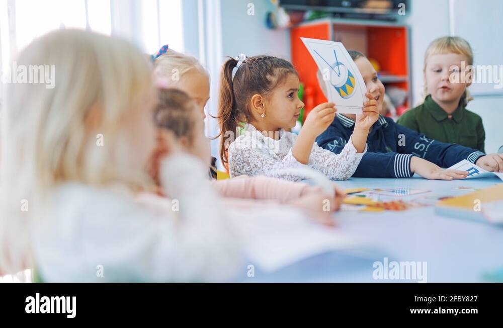 Little boys and girls study at school with pictures. Elementary school ...