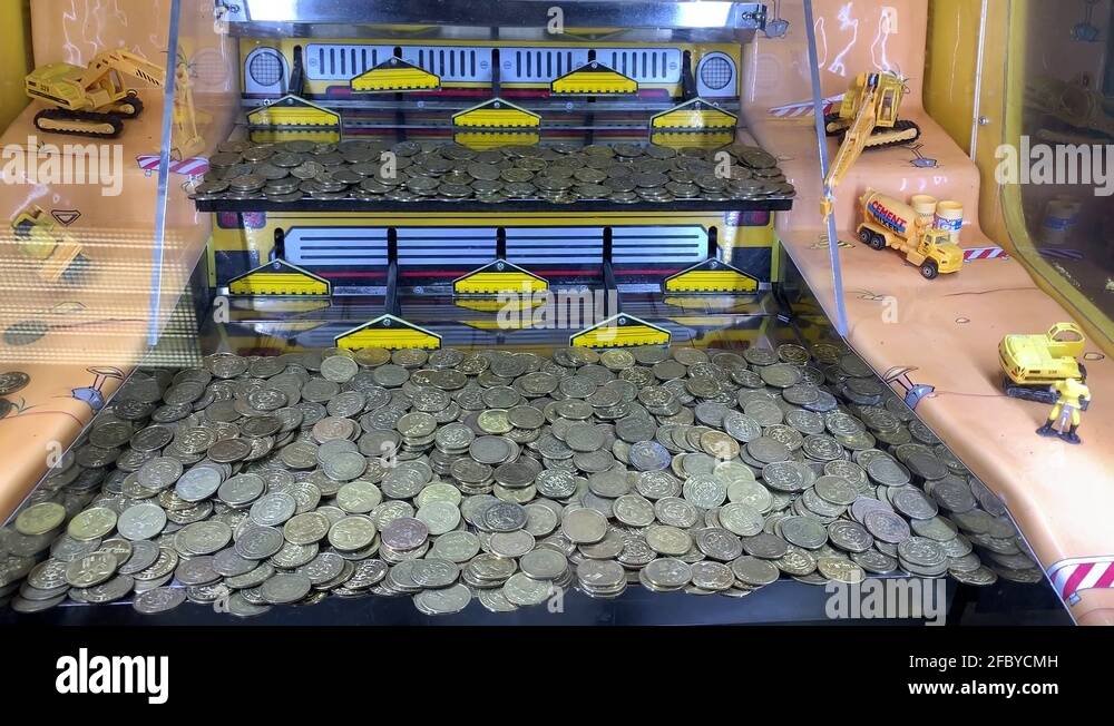 A coin pusher game filled with tokens at Chuck E. Cheese restaurant and ...