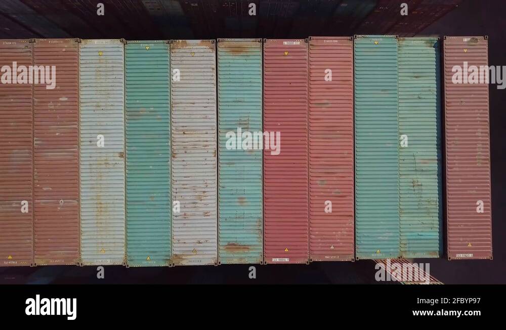 Colorful shipping containers with trucks and cargo carriers vertical ...