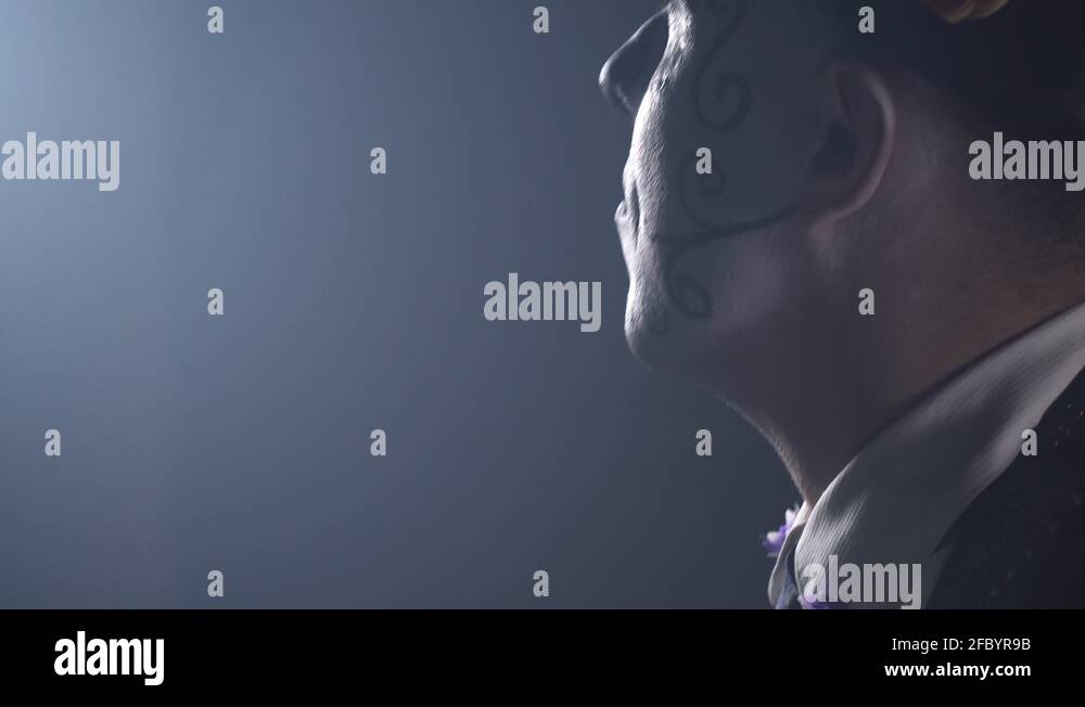 Intimidating man with the makeup of a skull is turning around and ...