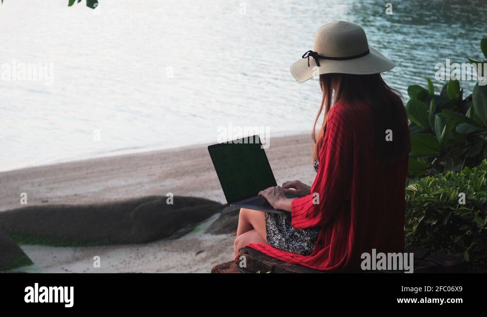 Woman Working on Beach near Sea on Sunset 4K. Green Screen Mock up ...