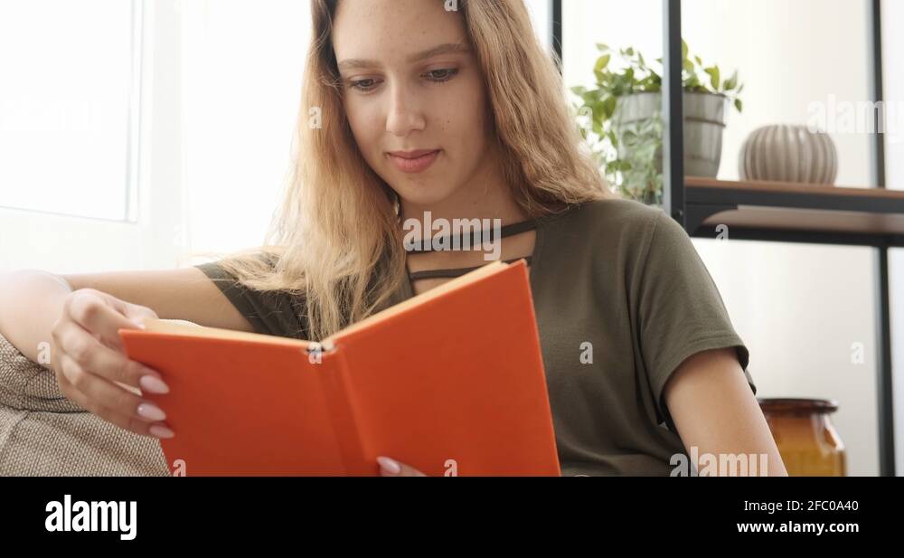 Teenage girl reading a book Stock Video Footage - Alamy