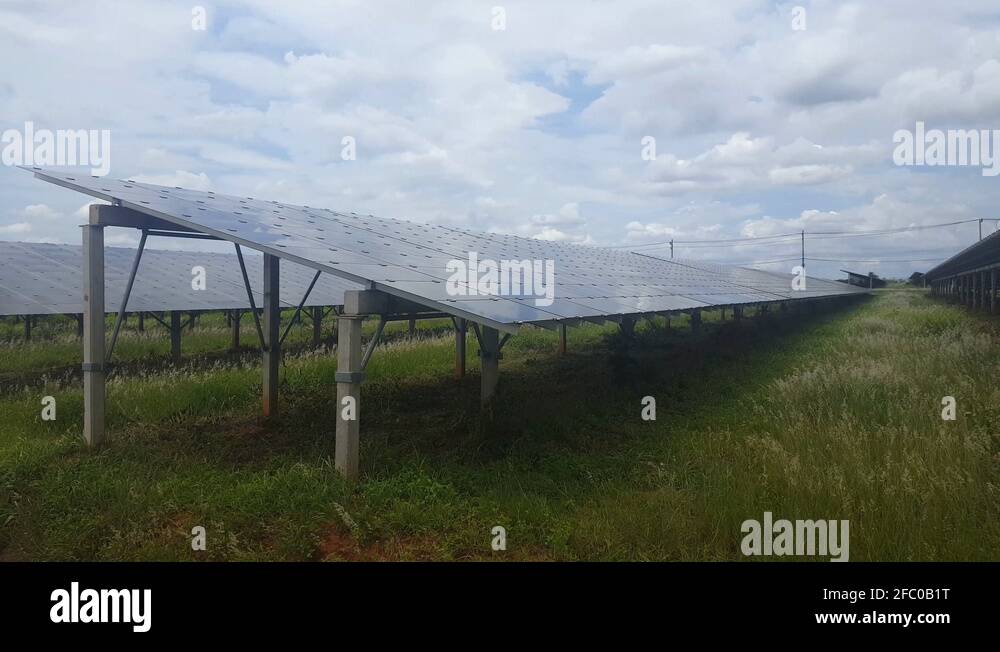 Pan to the right of a big solar plant with big photovoltaic array on a ...