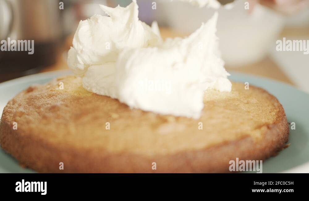 Spreading buttercream icing on Victoria Sponge Cake Closeup Stock Video ...