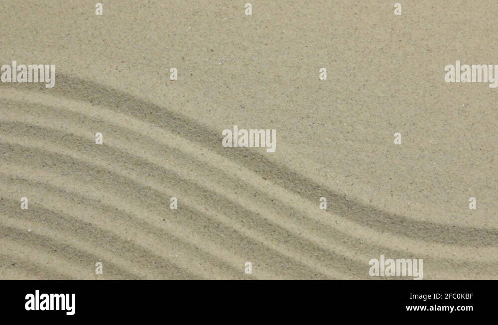 Unusual sand texture. Drawn lines and zigzags in the sand. With space ...