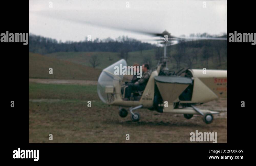 1940s: Helicopter slowly takes off with two men in the cockpit, flies ...