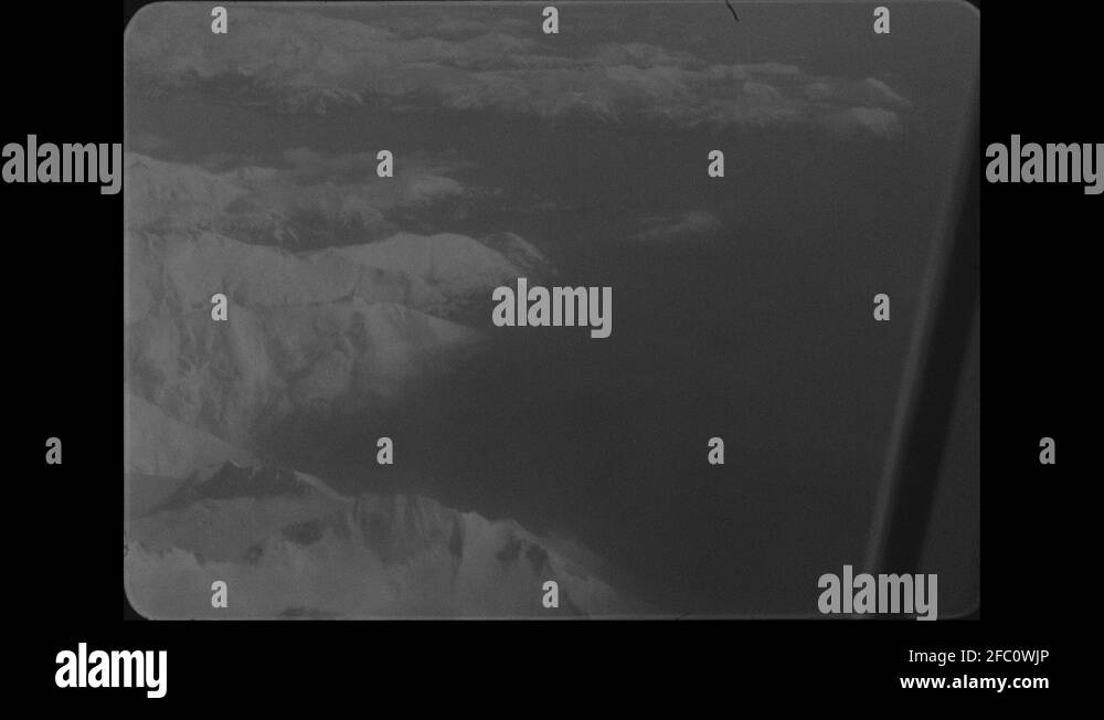 1960s: ALASKA: tundra and snow from above. Snow from above. Wing of ...