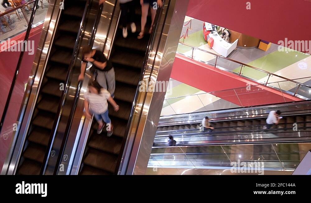 Fast moving Escalators In big modern shopping mall. Consumption concept ...