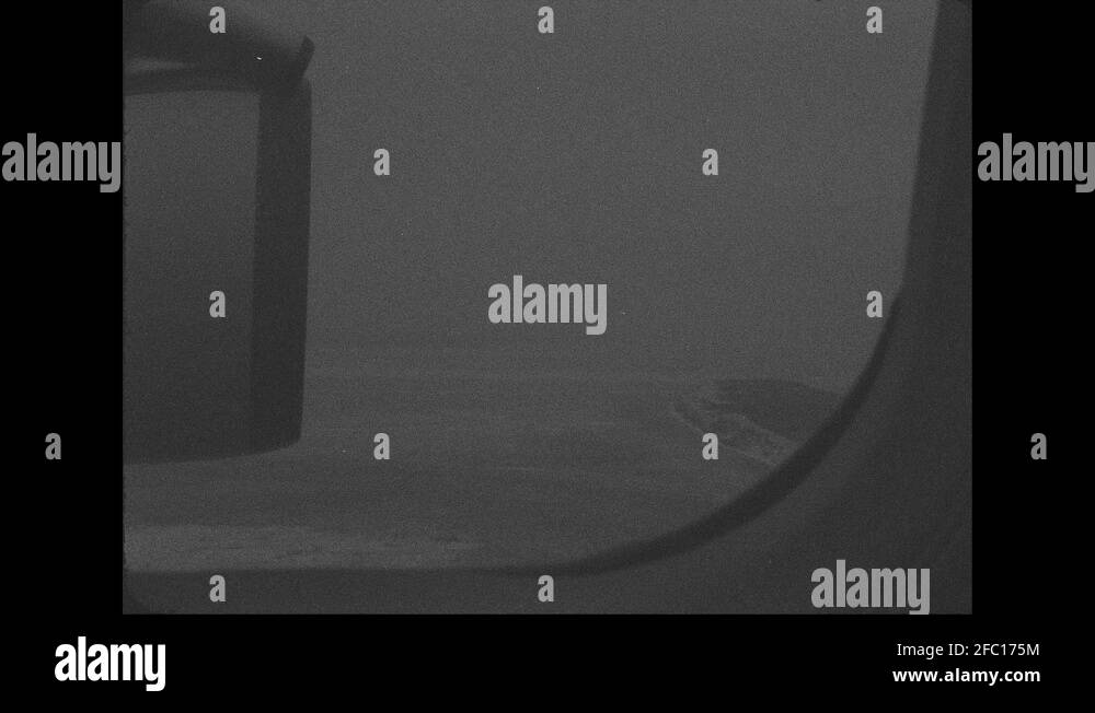 1960s: ALASKA: view through window of plane. Wing and engine on plane ...