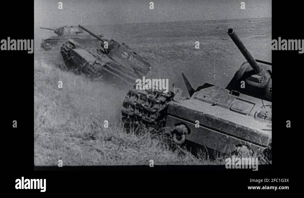 1950s: Tanks drive up hill. Soldiers walking by tank. Soldiers run past ...