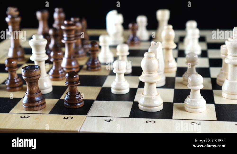 Chess board turns slowly around its axis. Close up 4K video. Black ...