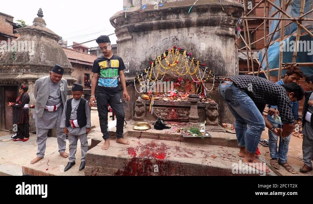 Man washing blood off has hands in front of Kathmandu shrine after ...