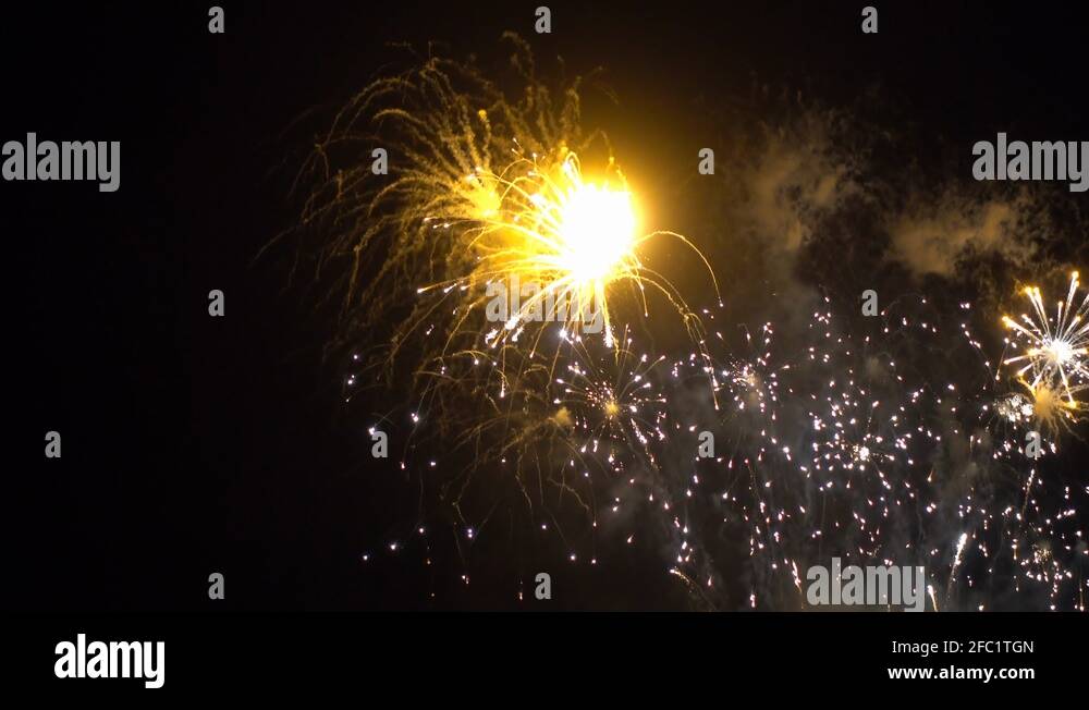 Sparkling fireworks display lights up the night sky. Outdoor ...