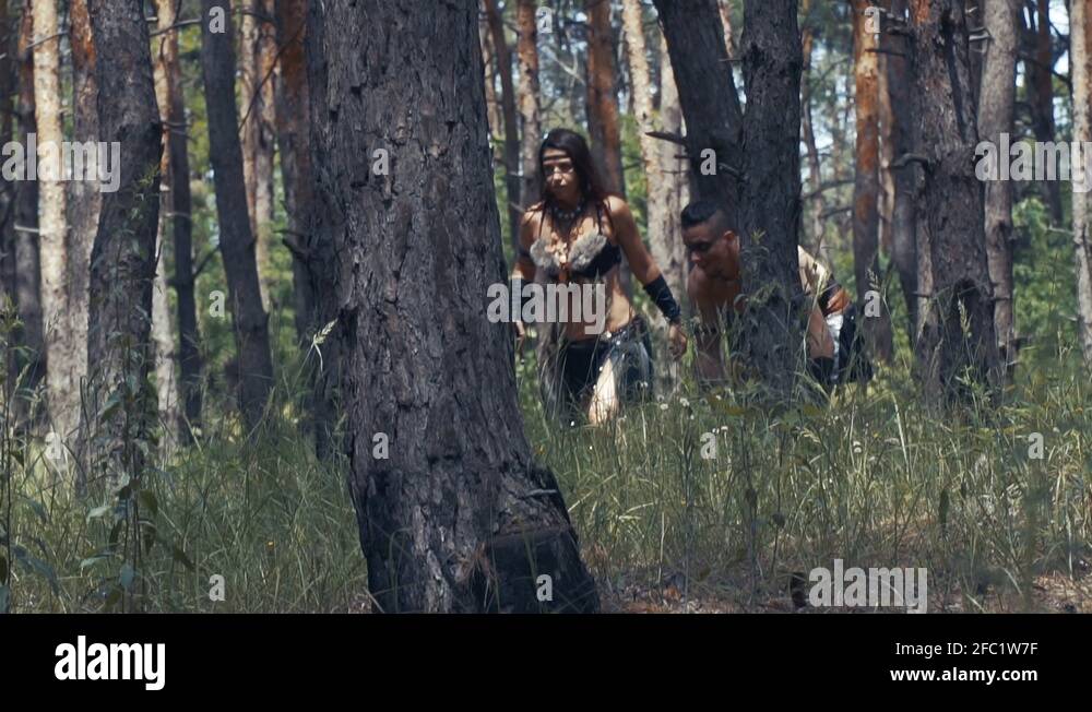 Scary big barbarian man is chasing an amazon woman in the forest Stock ...