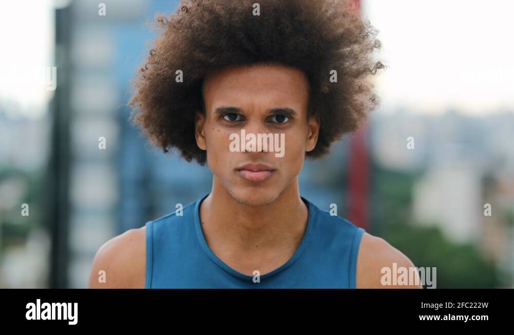 Angry african man screaming from the top of his lungs looking to camera ...