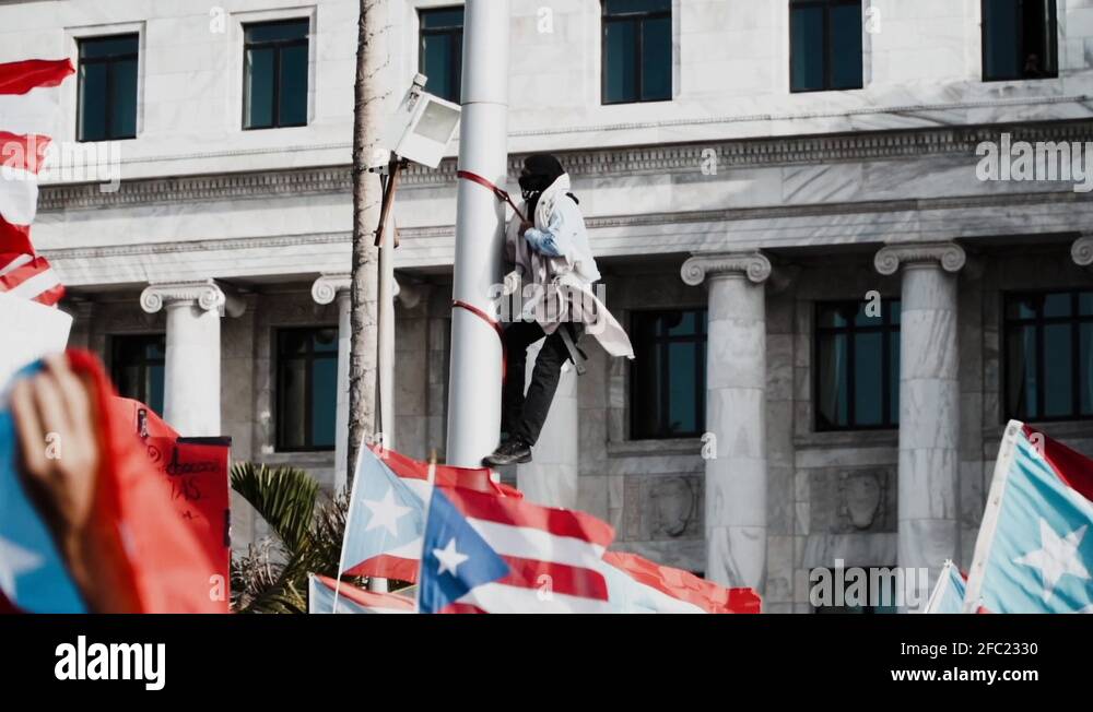 Man climbs flag pole to replace the American flag as hundreds of ...