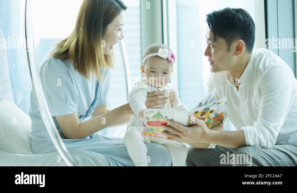 Chinese Asian family baby enjoying learning educational book Stock ...