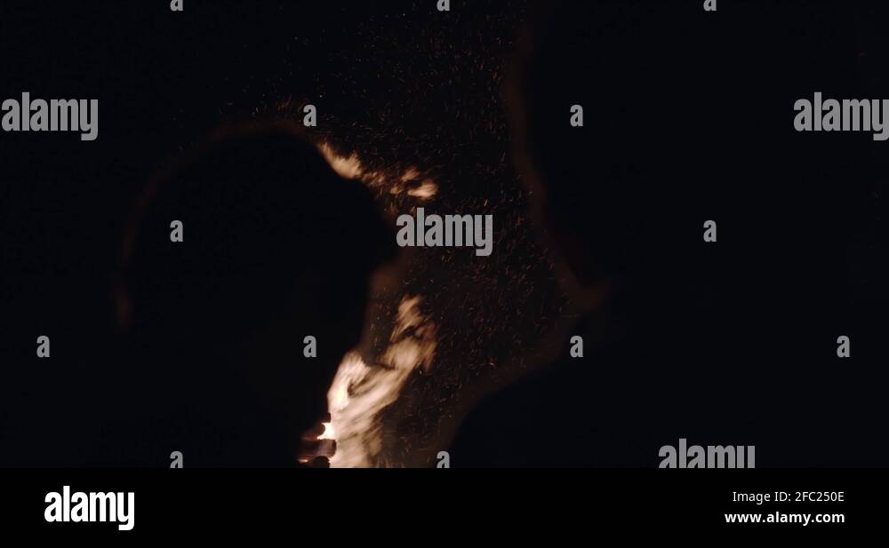 People are looking at Fire flames and sparks in sacrificial fire. slow ...