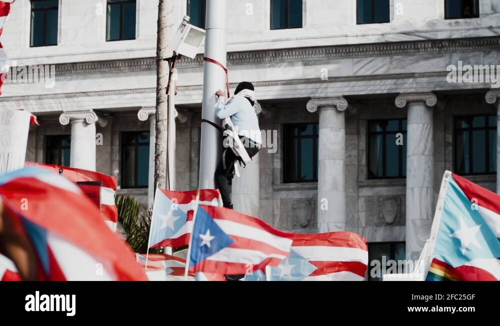 SLOW MOTION: man climbs flag pole to replace the American flag as ...