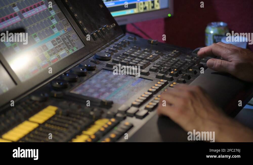 Hands using a control panel in a control room, during a live event ...