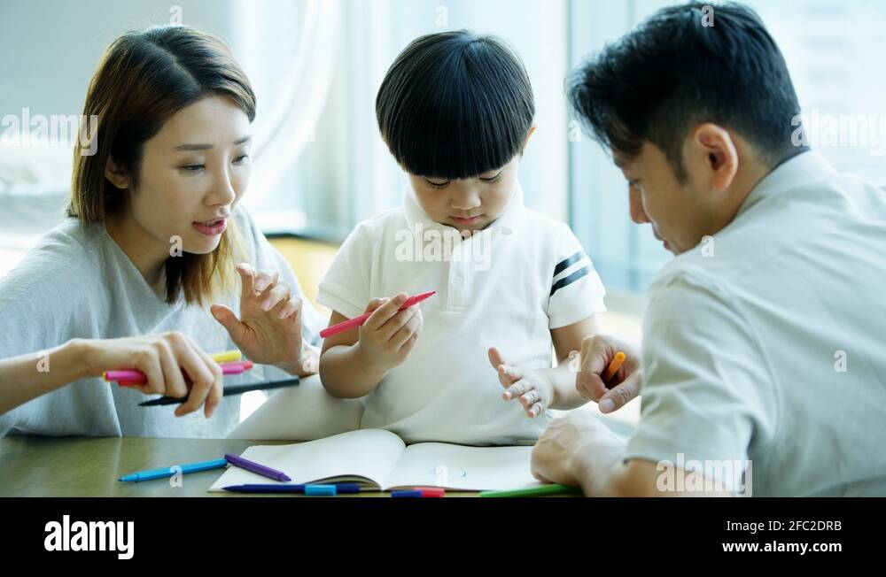 Chinese Asian family enjoying colouring art project together Stock ...