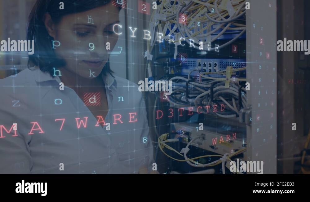 Woman working in a server room while danger messages move and flash in ...